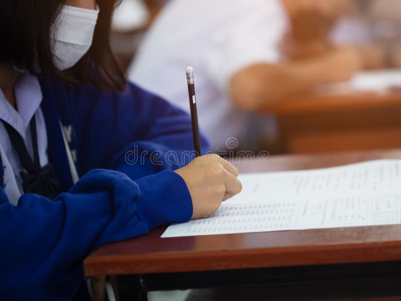 Close Up Hand of Students Reading and Taking Exam Sheets Exercises ...