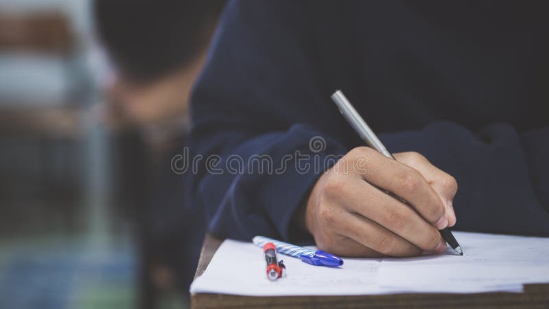 Close Up Hand of Students Reading and Taking Exam Sheets Exercises ...