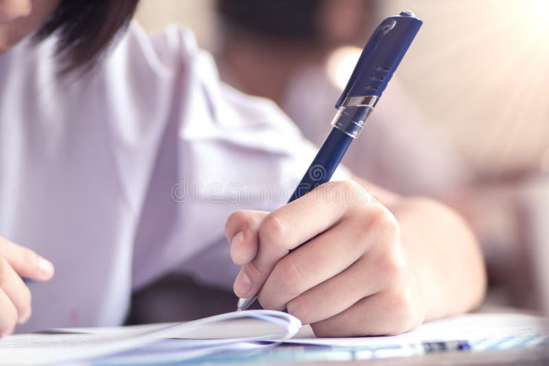 Close Up Hand of Students Reading and Taking Exam Sheets Exercises ...