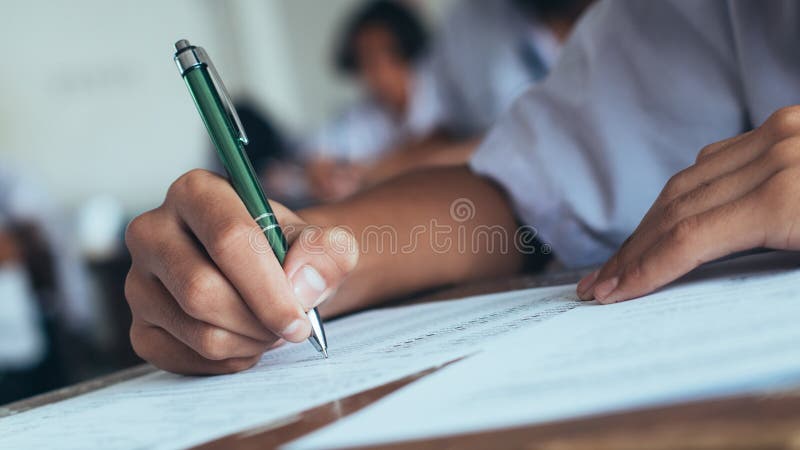 Close Up Hand of Students Reading and Taking Exam Sheets Exercises ...