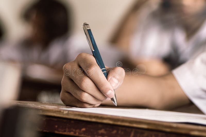 Close Up Hand of Students Reading and Taking Exam Sheets Exercises ...