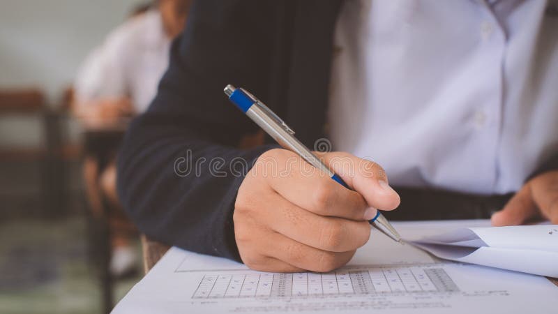 Close Up Hand of Students Reading and Taking Exam Sheets Exercises ...