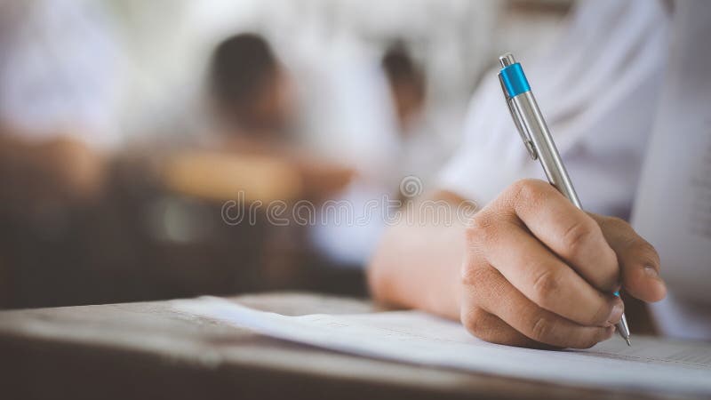 Close Up Hand of Students Reading and Taking Exam Sheets Exercises ...