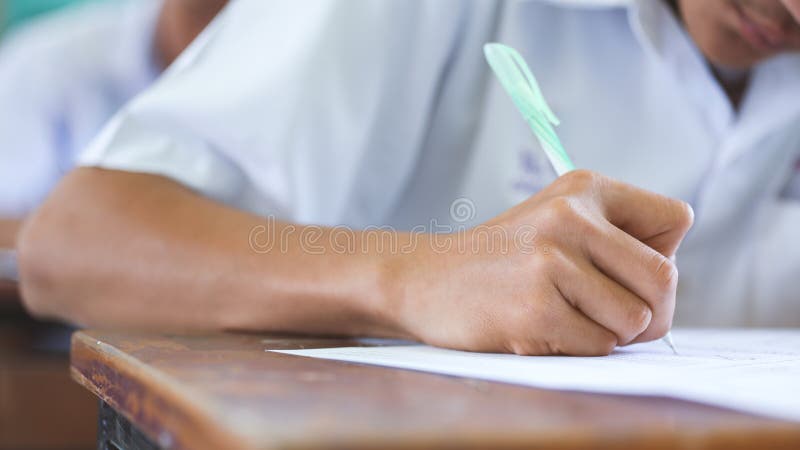 Close Up Hand of Students Reading and Taking Exam Sheets Exercises ...