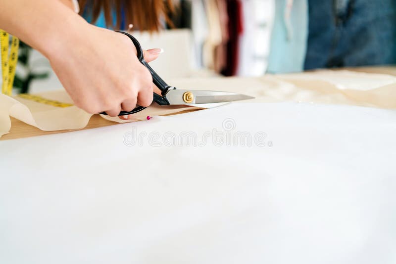 Close Up Hand of Tailor or Fashion Designer Cutting Fabric with ...