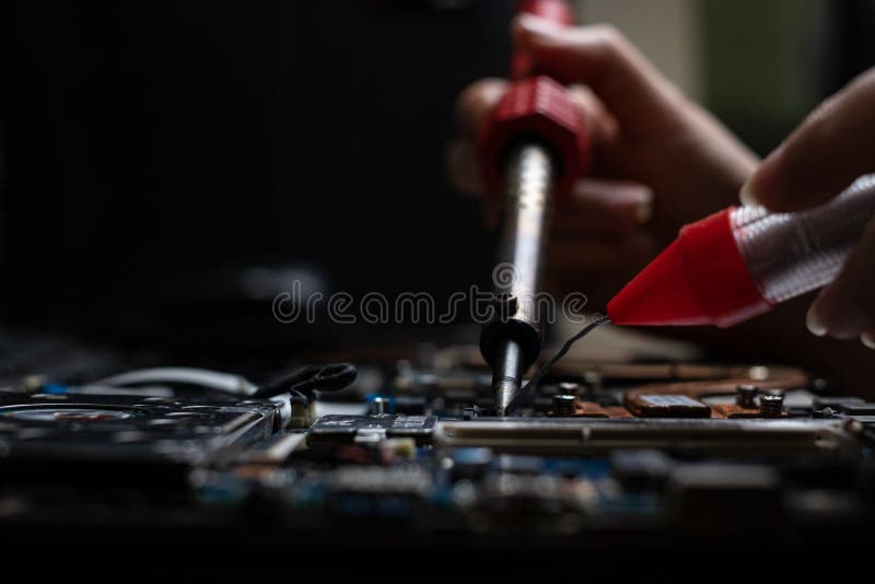 Hand Technician Repairing Broken Laptop Notebook Computer with Electric ...