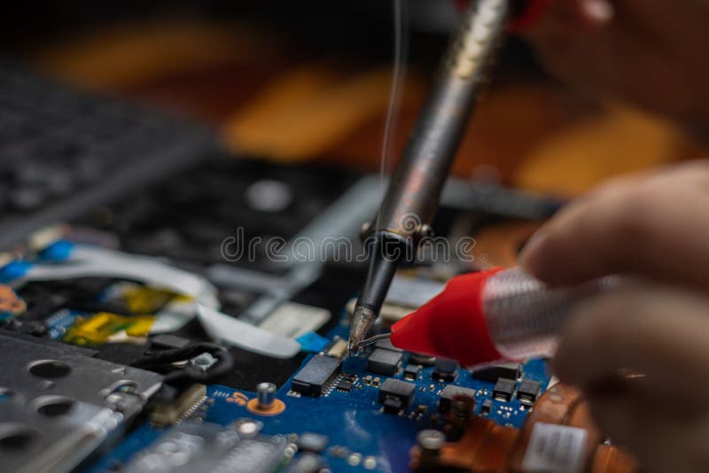 Hand Technician Repairing Broken Laptop Notebook Computer with Electric ...