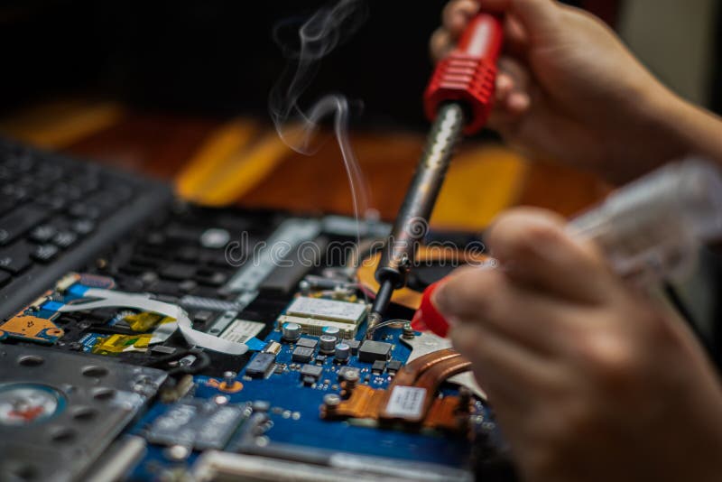 Hand Technician Repairing Broken Laptop Notebook Computer with Electric ...