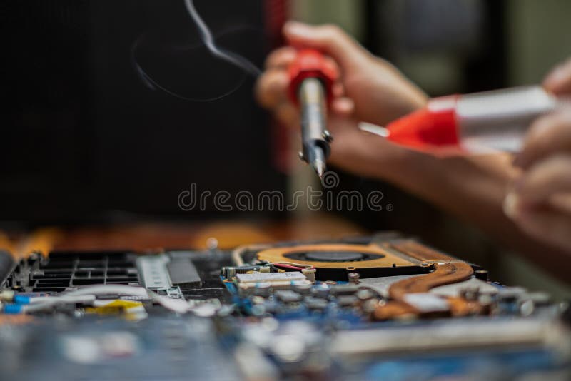 Hand Technician Repairing Broken Laptop Notebook Computer with Electric ...