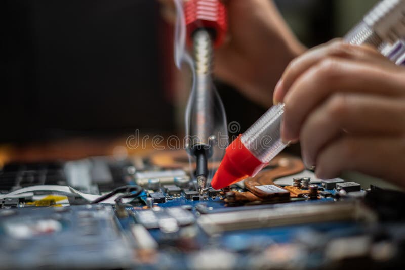 Hand Technician Repairing Broken Laptop Notebook Computer with Electric ...