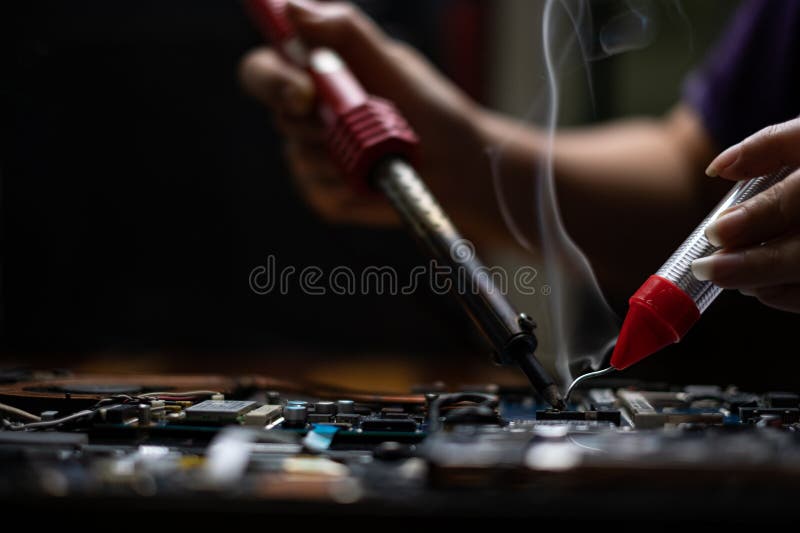 Hand Technician Repairing Broken Laptop Notebook Computer with Electric ...
