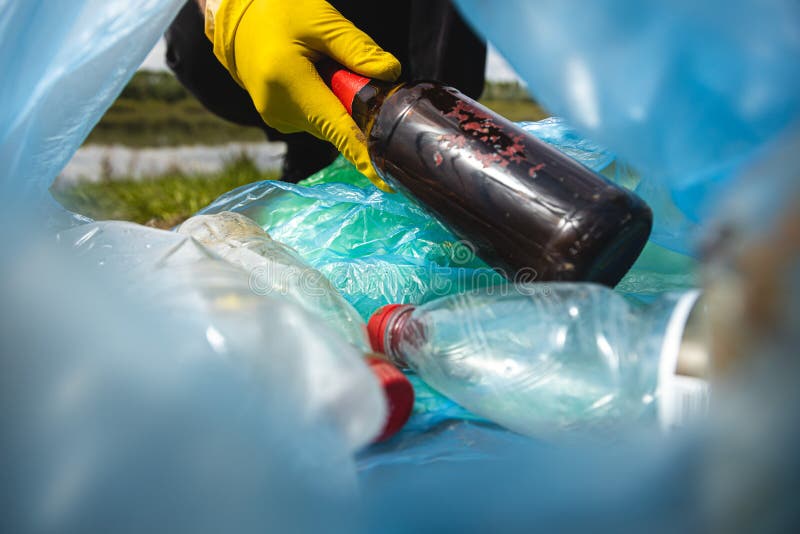 Close-up of a Hand Throwing Garbage into a Plastic Bag. View from ...