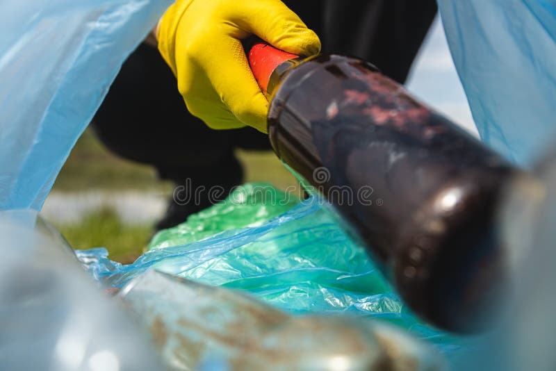 Close-up of a Hand Throwing Garbage into a Plastic Bag. View from ...