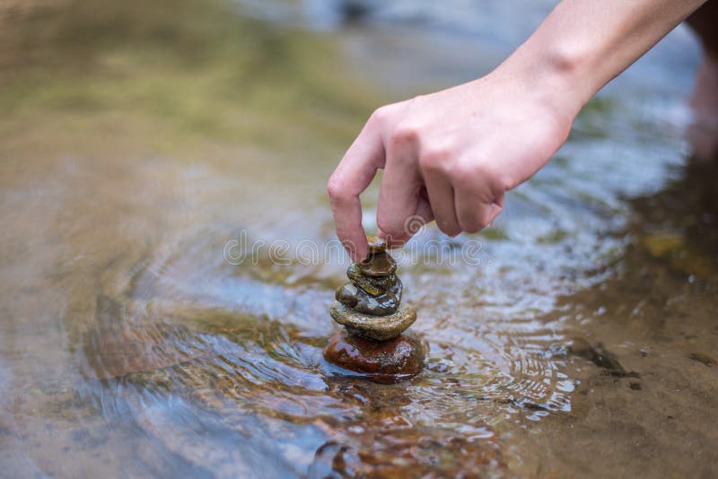 Close Up Hand To Doing Stone Stacked in Water River Stock Image - Image ...