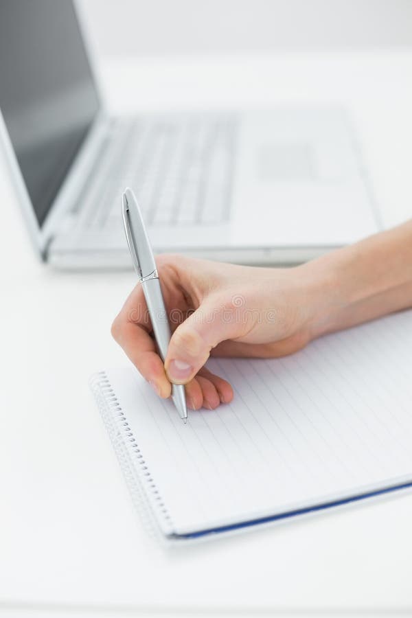Close Up of a Hand Writing Notes by Laptop Stock Photo - Image of ...