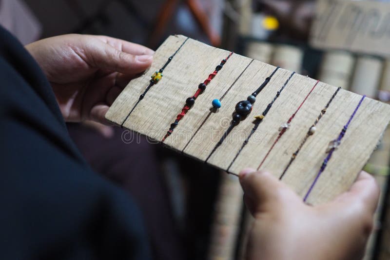 Close Up of Handmade Gemstone Necklace with Nylon String Being Selected ...