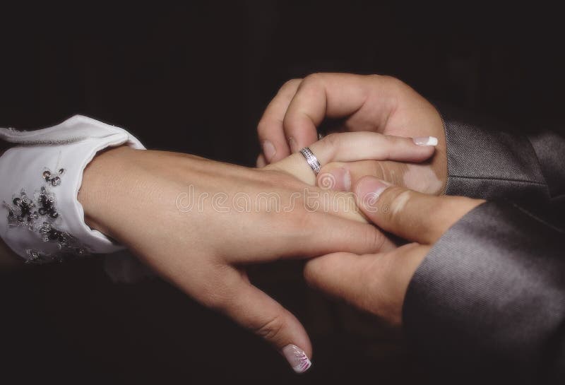 Close Up Hands of Bride and Groom Putting on a Wedding Rings Stock ...