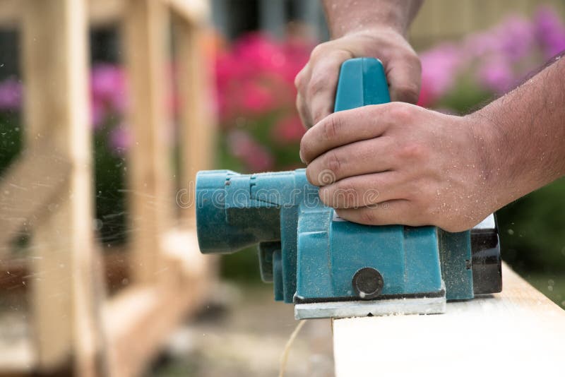 Close Up Hands of Carpenter Working with Electric Planer on Wooden ...