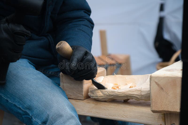 Close Up of Hands of Craftsman Carve with a Gouge in the Hands on the ...