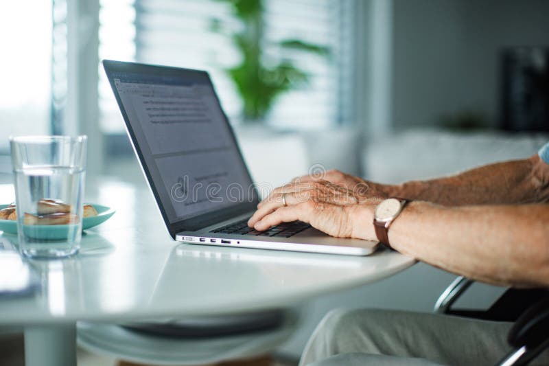 Close-up of the Hands of an Elderly Man Typing on a Laptop Keyboard ...