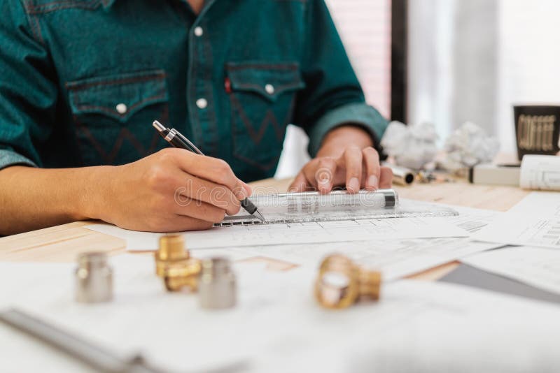 Close Up Hands of an Engineer Working and Checking on Blueprints ...