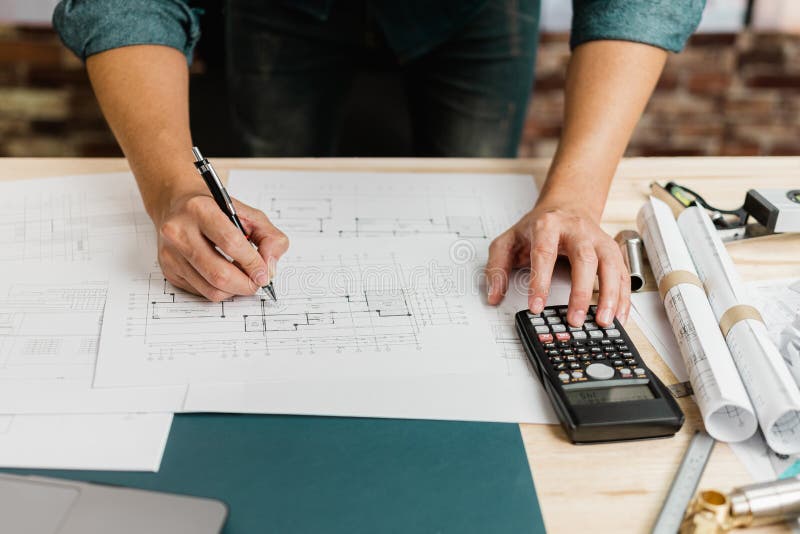 Close Up Hands of an Engineer Working and Checking on Blueprints with ...