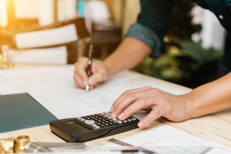 Close Up Hands of an Engineer Working and Checking on Blueprints with ...