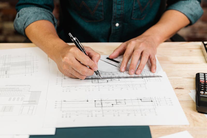 Close Up Hands of an Engineer Working and Sketching on Blueprints ...