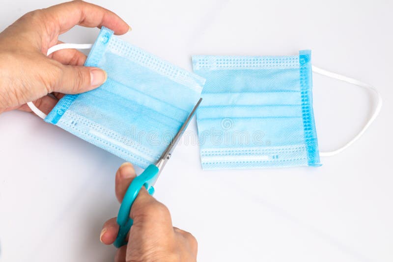 Close-up Hands of Girl Using Scissors To Cut Face Mask on White ...