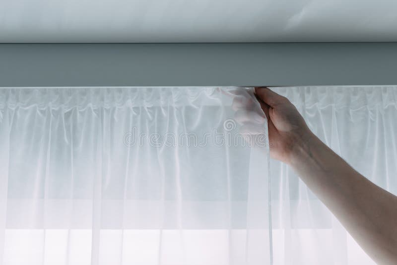Close Up of Hands Hanging Curtain on Ceiling Ledge. Interior Decor ...