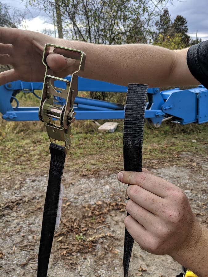 Close-Up of Hands Holding a Endless Ratchet Strap for Securing ...