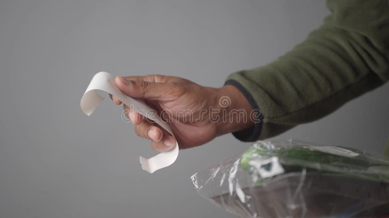 Close-Up of Hands Holding Receipt and Grocery Packet Stock Video ...