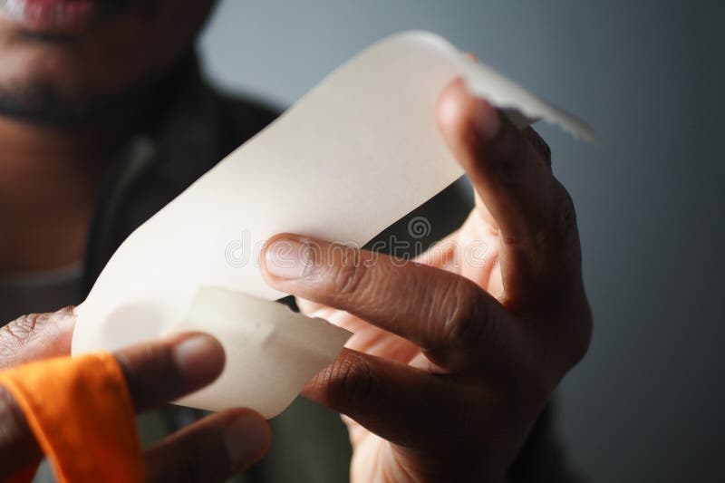 Close-Up of Hands Holding Receipt and Grocery Packet Stock Photo ...