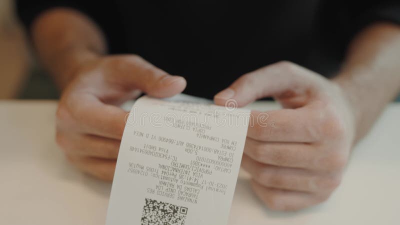 Close-Up of Hands Holding a Receipt with QR Code Stock Video - Video of ...