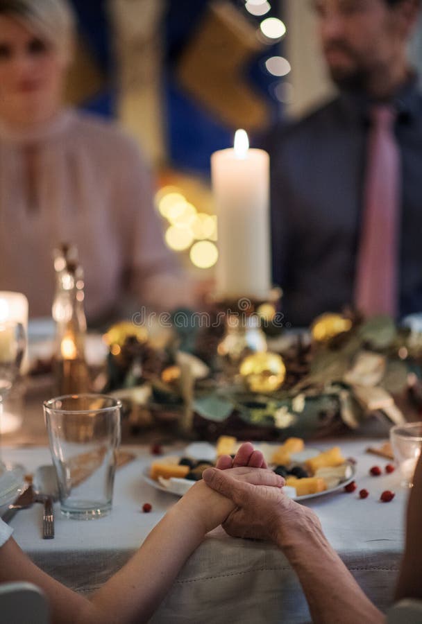 Close-up of Hands Holding Together at the Table at Christmas. Stock ...