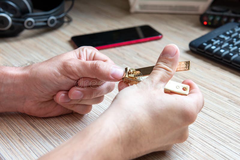 Man Cuts Nails on the Table at Home Stock Image - Image of cutter ...