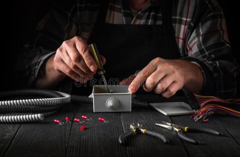 Close-up of Hands of a Master Electrician during Work. Installing a ...