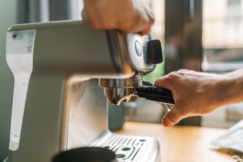 Close-up of Hands Operating an Espresso Machine in a Cozy Kitchen ...