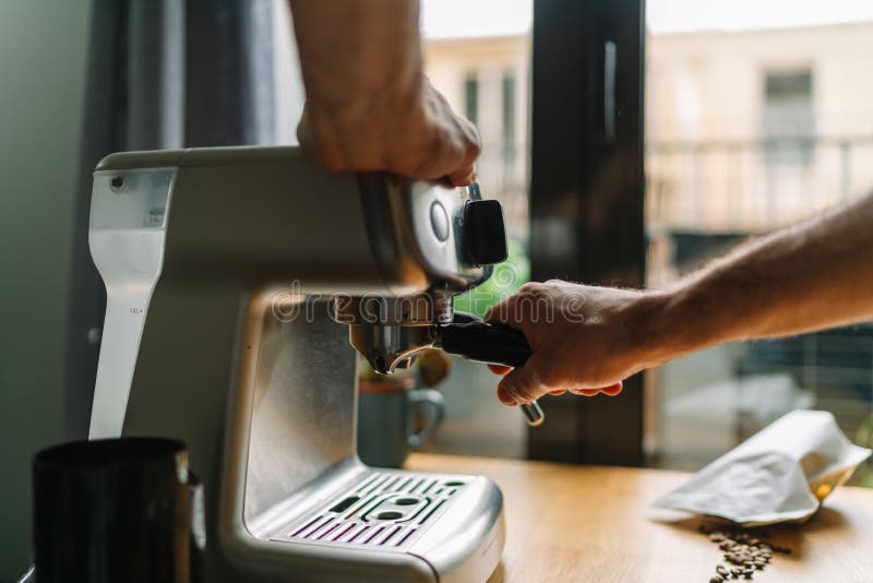 Close-up of Hands Operating an Espresso Machine in a Modern Kitchen ...