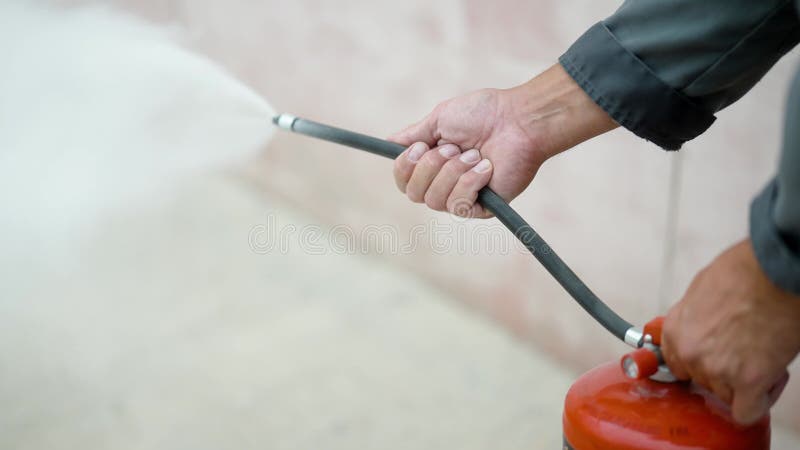 Close-up of Hands Operating a Fire Extinguisher during the Accident ...