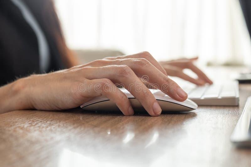 Close-up of Hands Operating a Mouse and Keyboard, Demonstrating ...