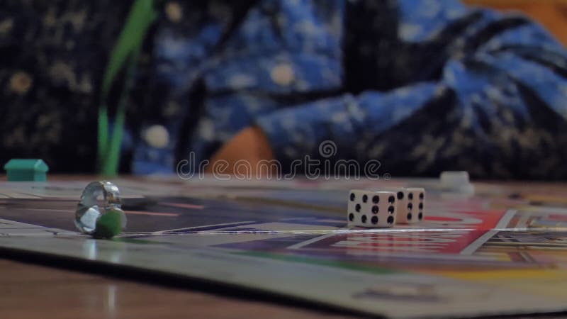 Close-up of the Hands of People Playing the Game Monopoly. Stock ...
