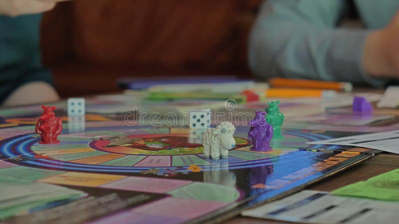 Close-up of the Hands of People Playing the Game Monopoly. Stock Video ...