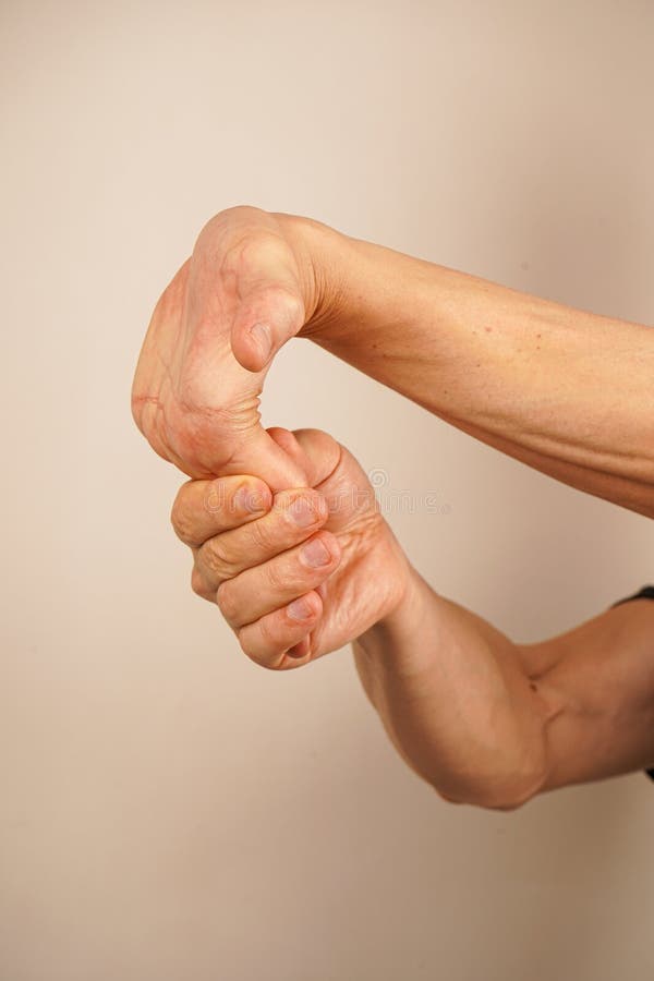 A Close-up of Hands Performing a Stretching Exercise. One Hand Pulls ...