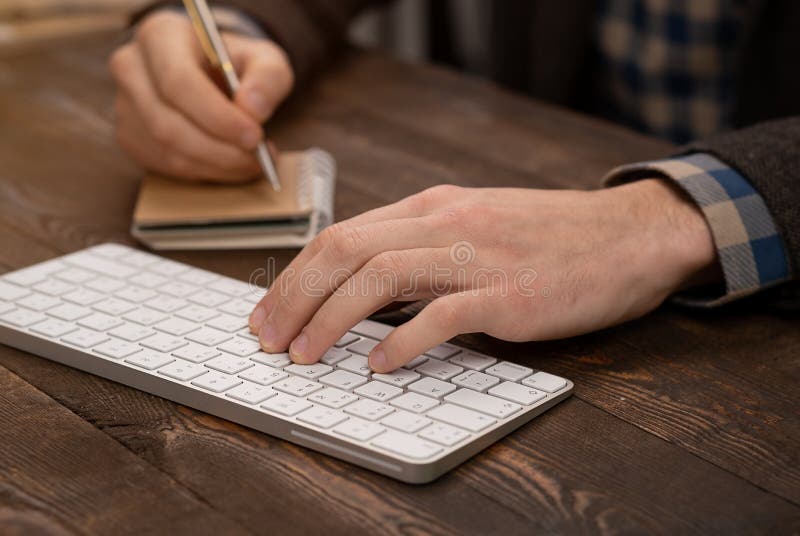 Close-up of Hands of Person Taking Noted on Paper White Typing on ...