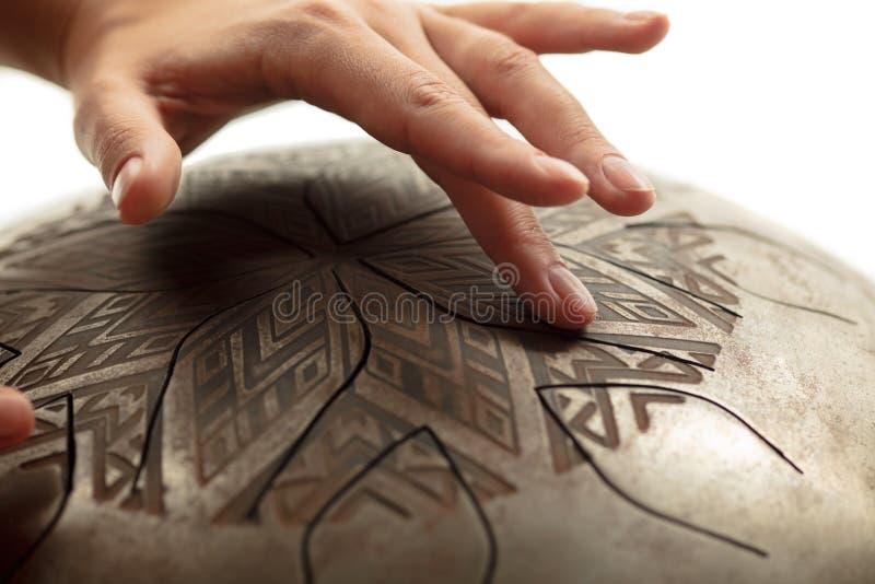 A Close Up of Hands Playing the Hank Drum on White Studio Background ...