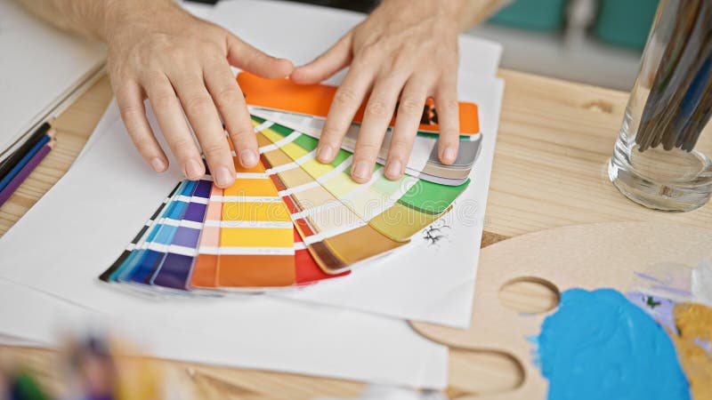 A Close-up of Hands Selecting a Color Swatch from a Palette, Indicative ...