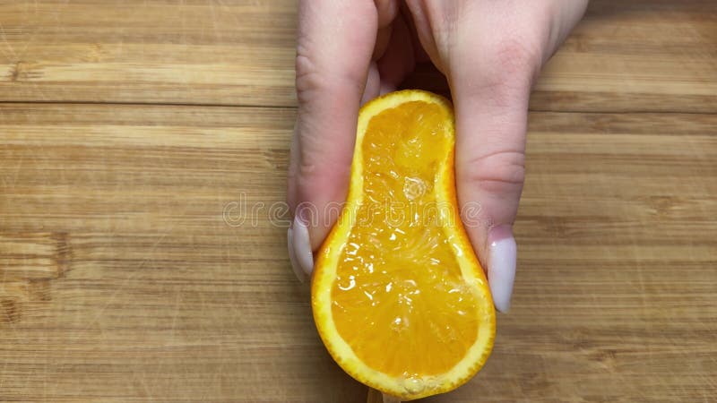 Close Up of Hands Squeezing Orange for Juice. Human Using Their Hands ...