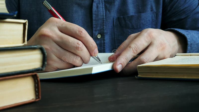 Close-up of Hands Taking Notes in a Notebook. a Man is Studying and ...