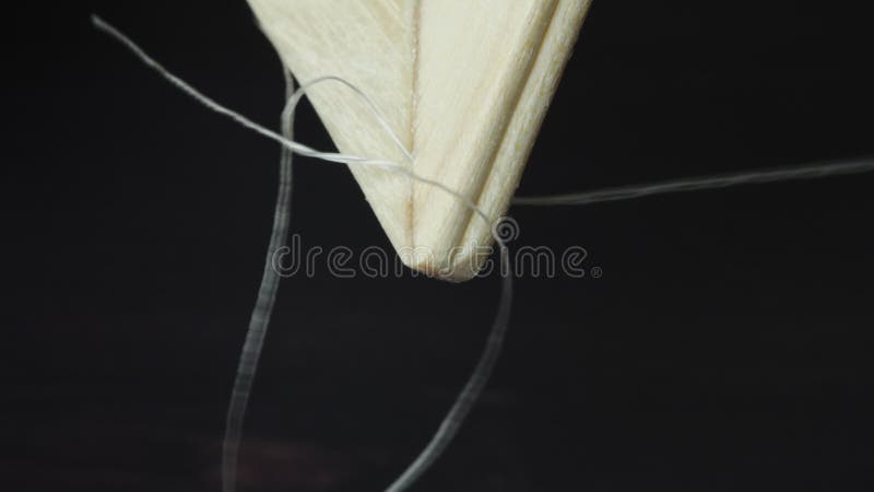 Close-up of Hands Threading Needle with Thread through Ice Cream Stick ...